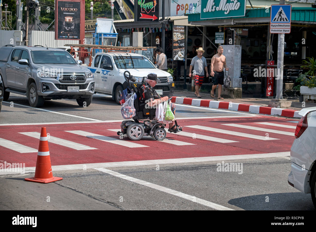 Man in wheelchair crossing road hi-res stock photography and images - Alamy