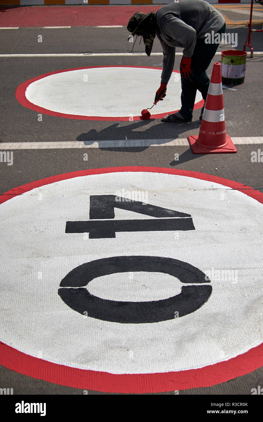 Road marking and speed sign warning painted by hand. Thailand Southeast ...