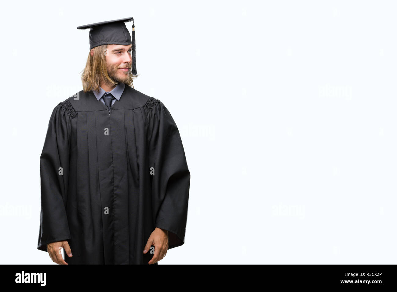 Young handsome graduated man with long hair over isolated background ...