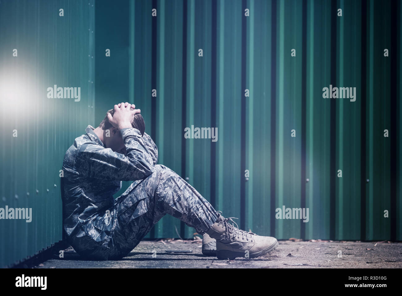 Frustrated military soldier sitting with hands on head Stock Photo - Alamy