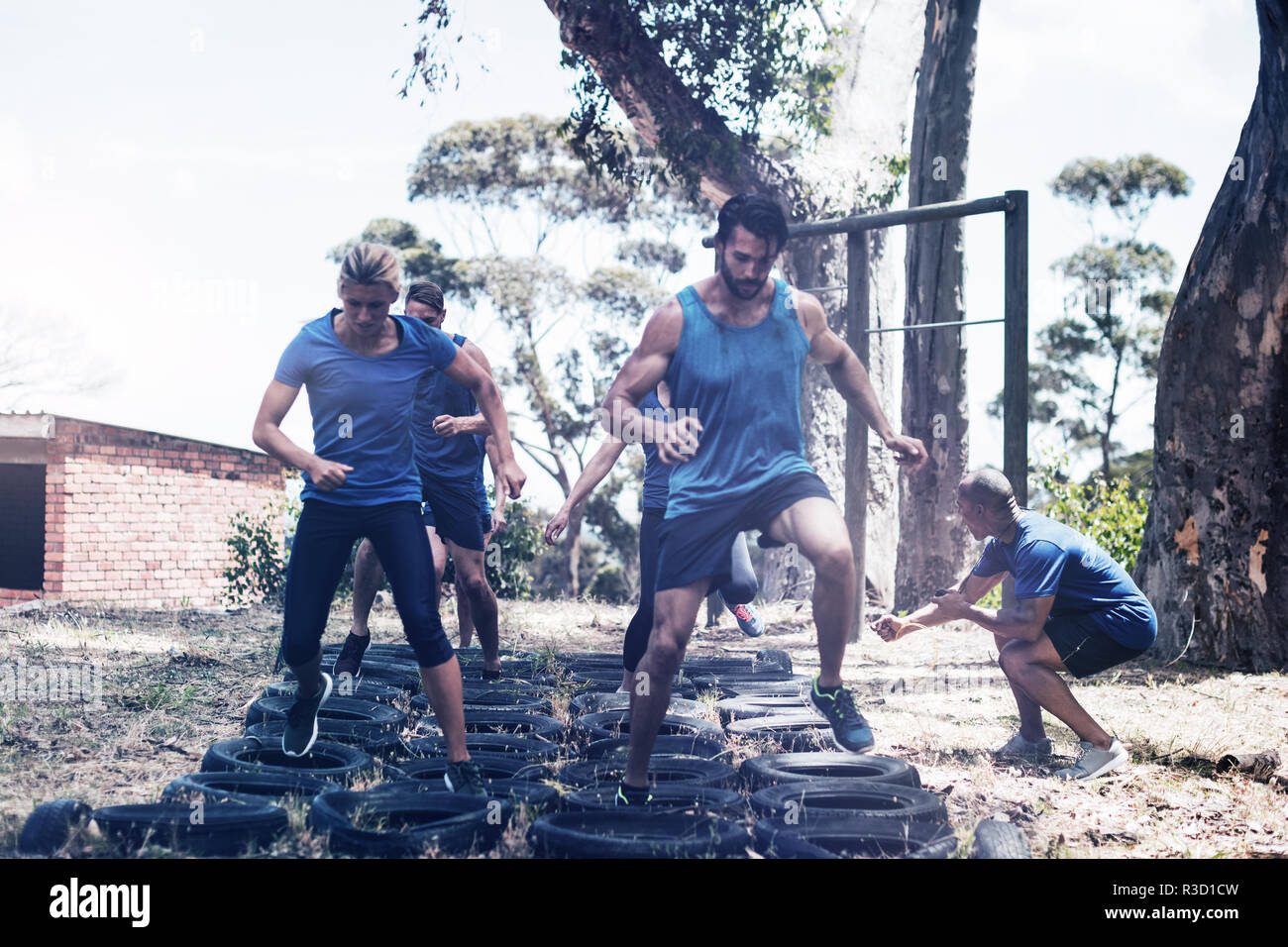 People receiving tire obstacle course training Stock Photo - Alamy