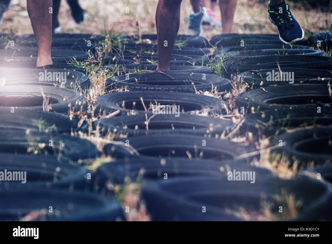 Low section of people receiving tire obstacle course training Stock ...
