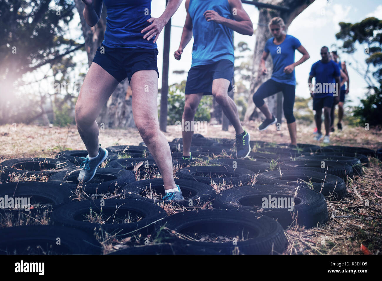 People receiving tire obstacle course training Stock Photo - Alamy