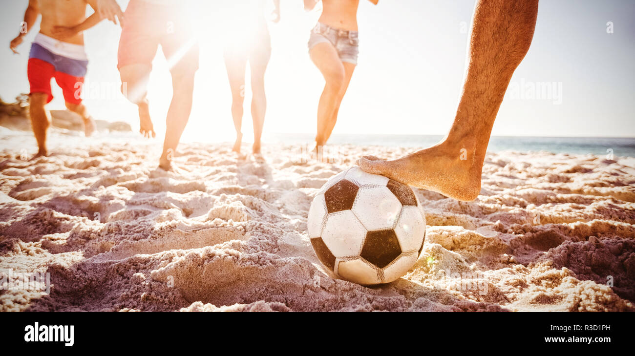 Friends playing football Stock Photo - Alamy
