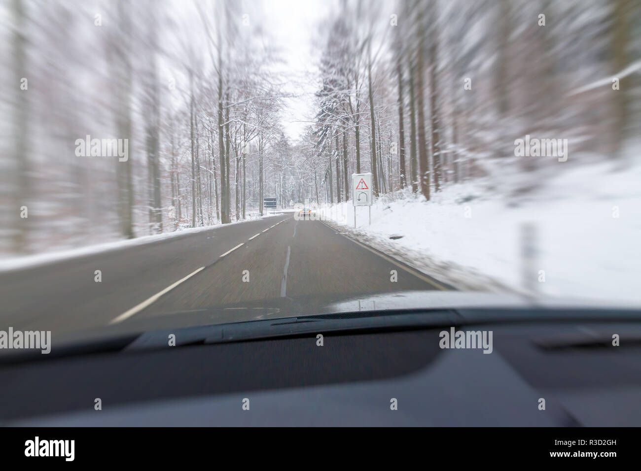 Road through snowy forest Stock Photo - Alamy
