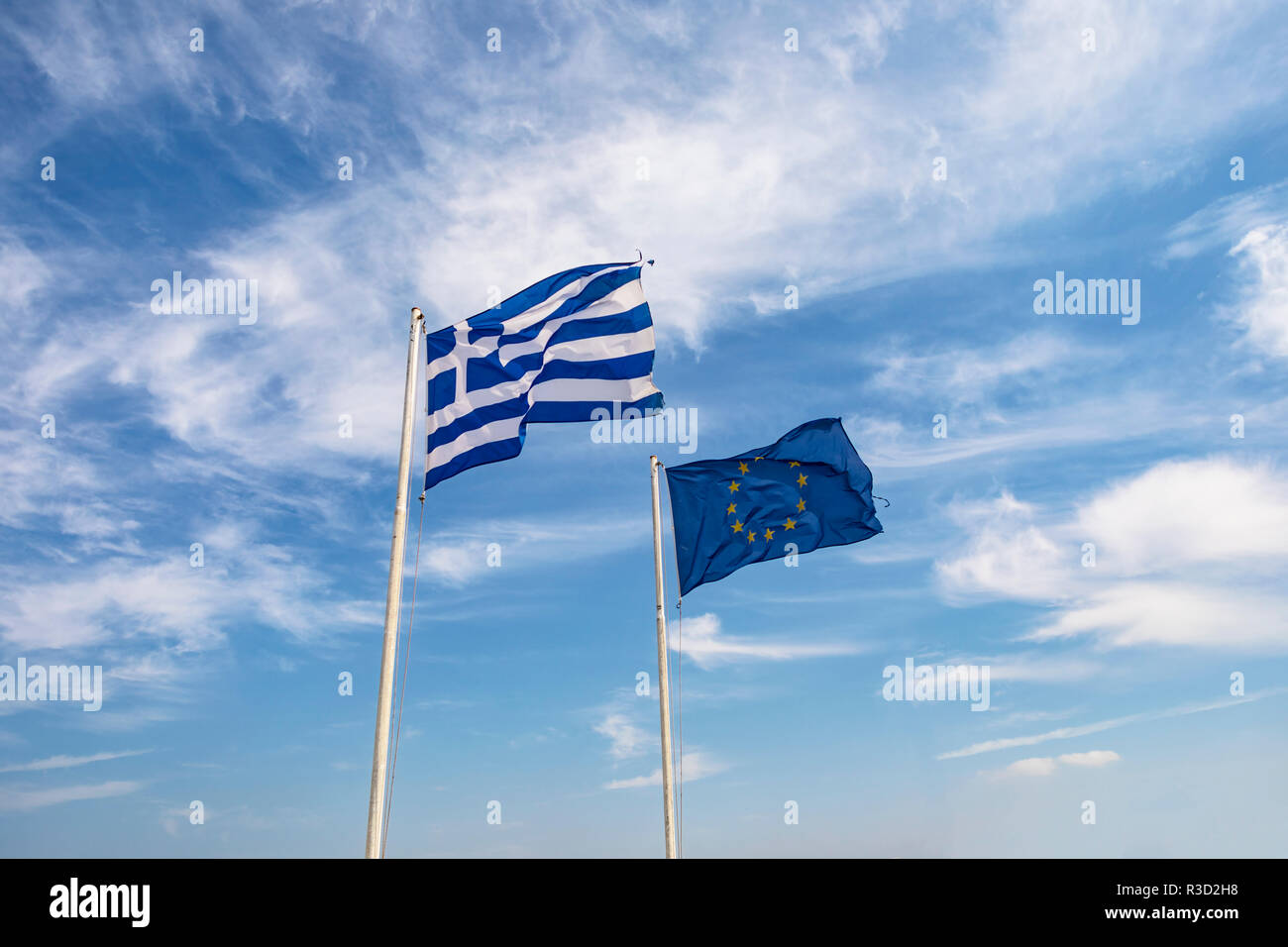 Greek flag and European Union flag floating in the wind side by side on ...