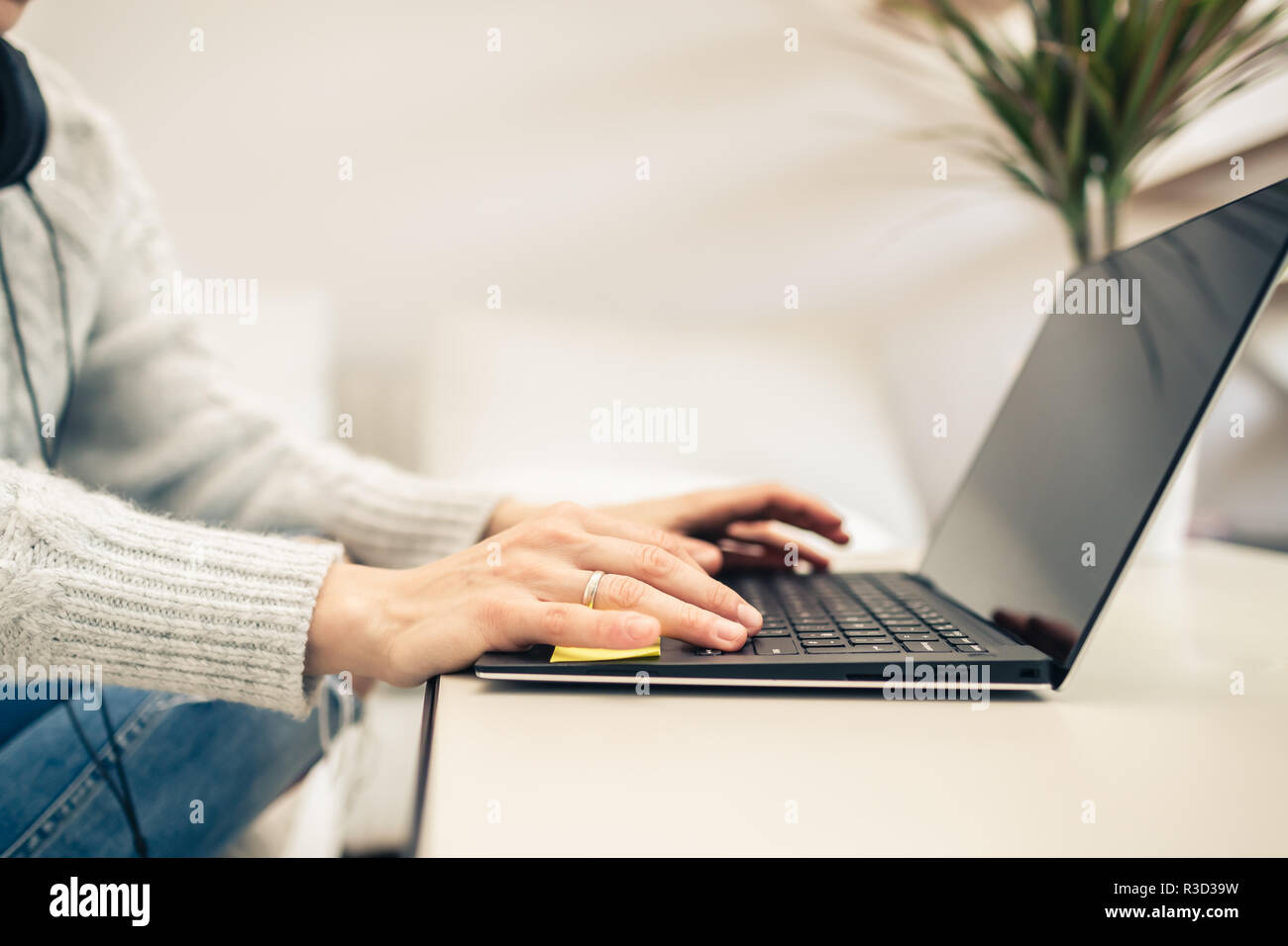Woman working from home on laptop computer. Home office from a warm ...