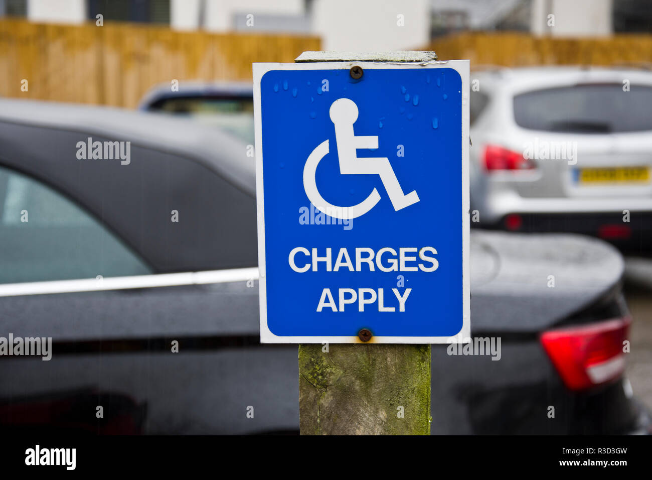 Sign reminding disabled drivers to pay for car parking Stock Photo - Alamy
