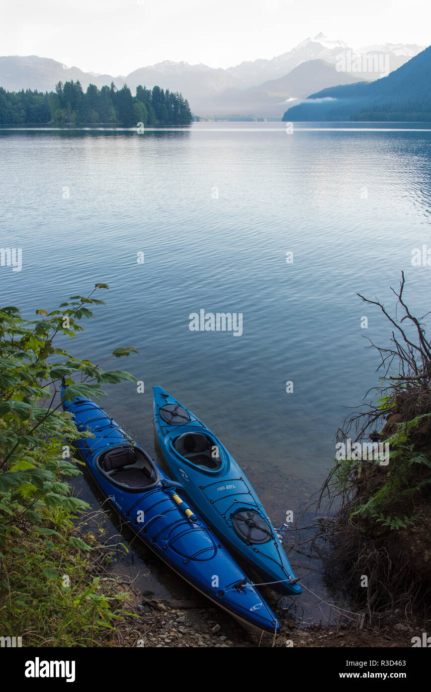 USA, WA. Kayaks tied at shore Anderson Point Campground. Mt. Shuksan ...