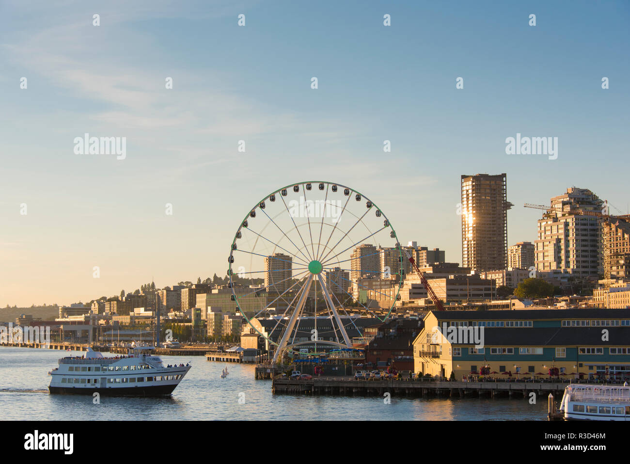 USA, WA, Seattle. Elliott Bay waterfront late summer evening. Ferris ...