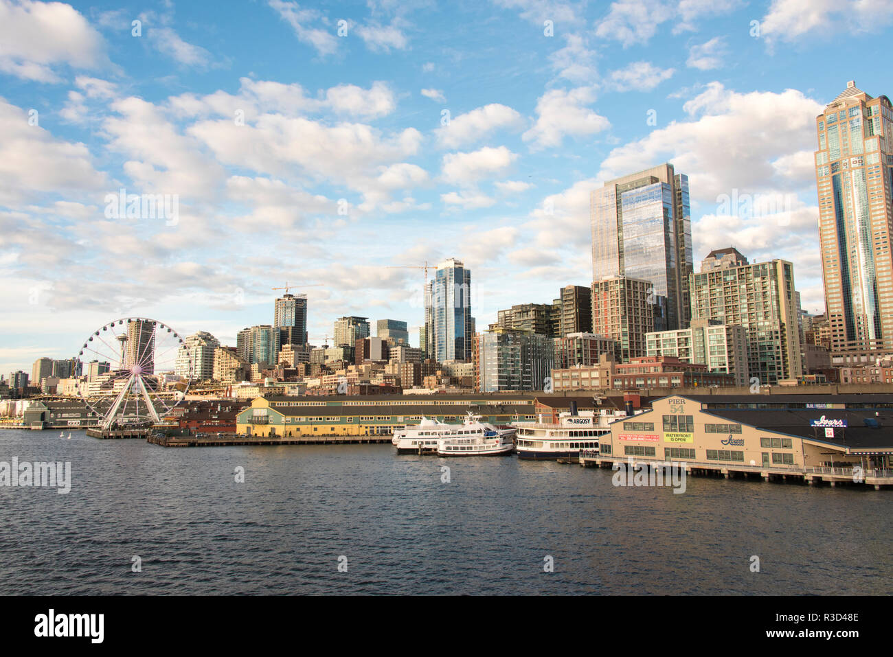 Seattle waterfront and skyline. Clouds reflected in glass buildings ...