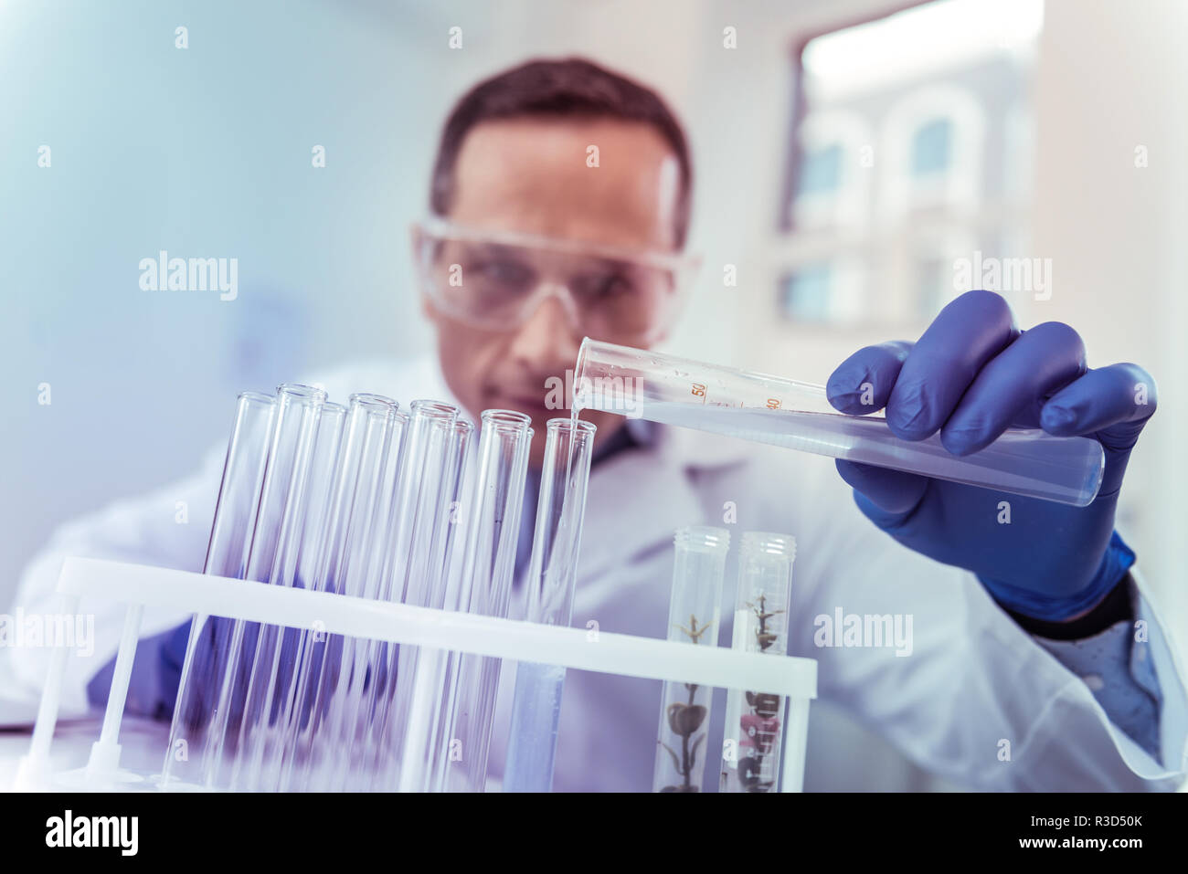 Chemical experiment. Professional medical worker sitting at his ...