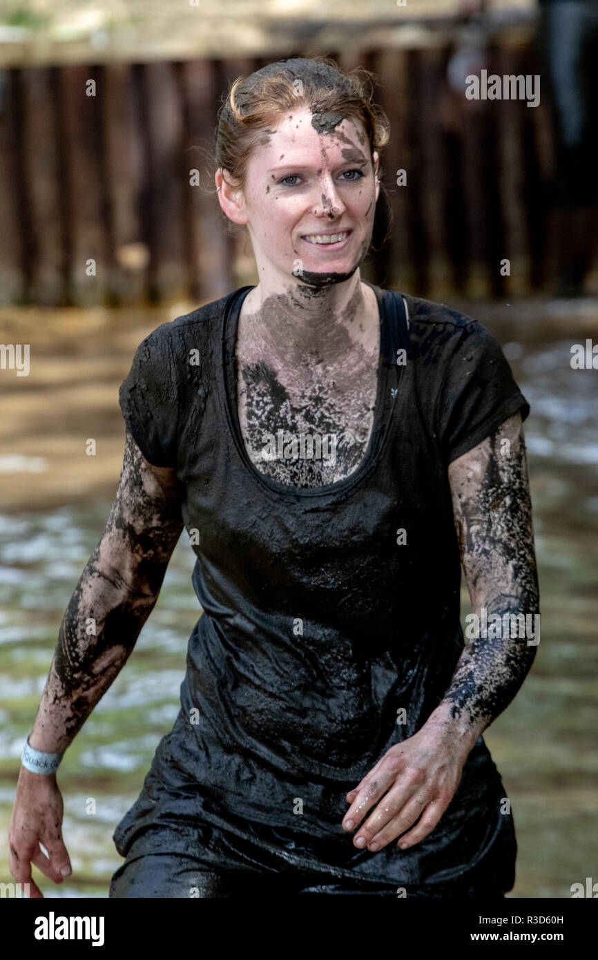 Rather muddy lady wading through a water crossing Stock Photo - Alamy