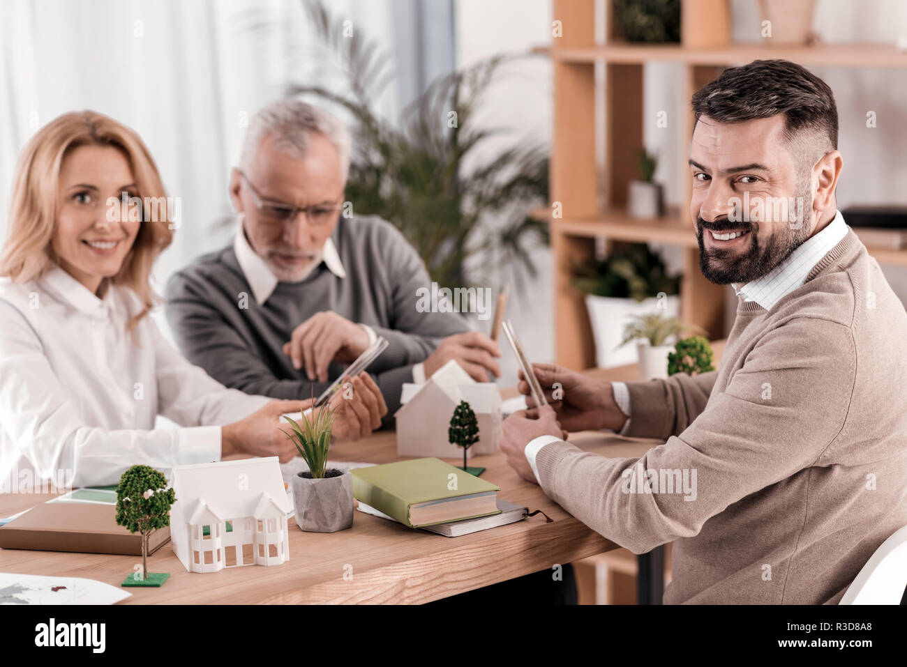 My working day. Content bearded ecologist sitting the table and his ...