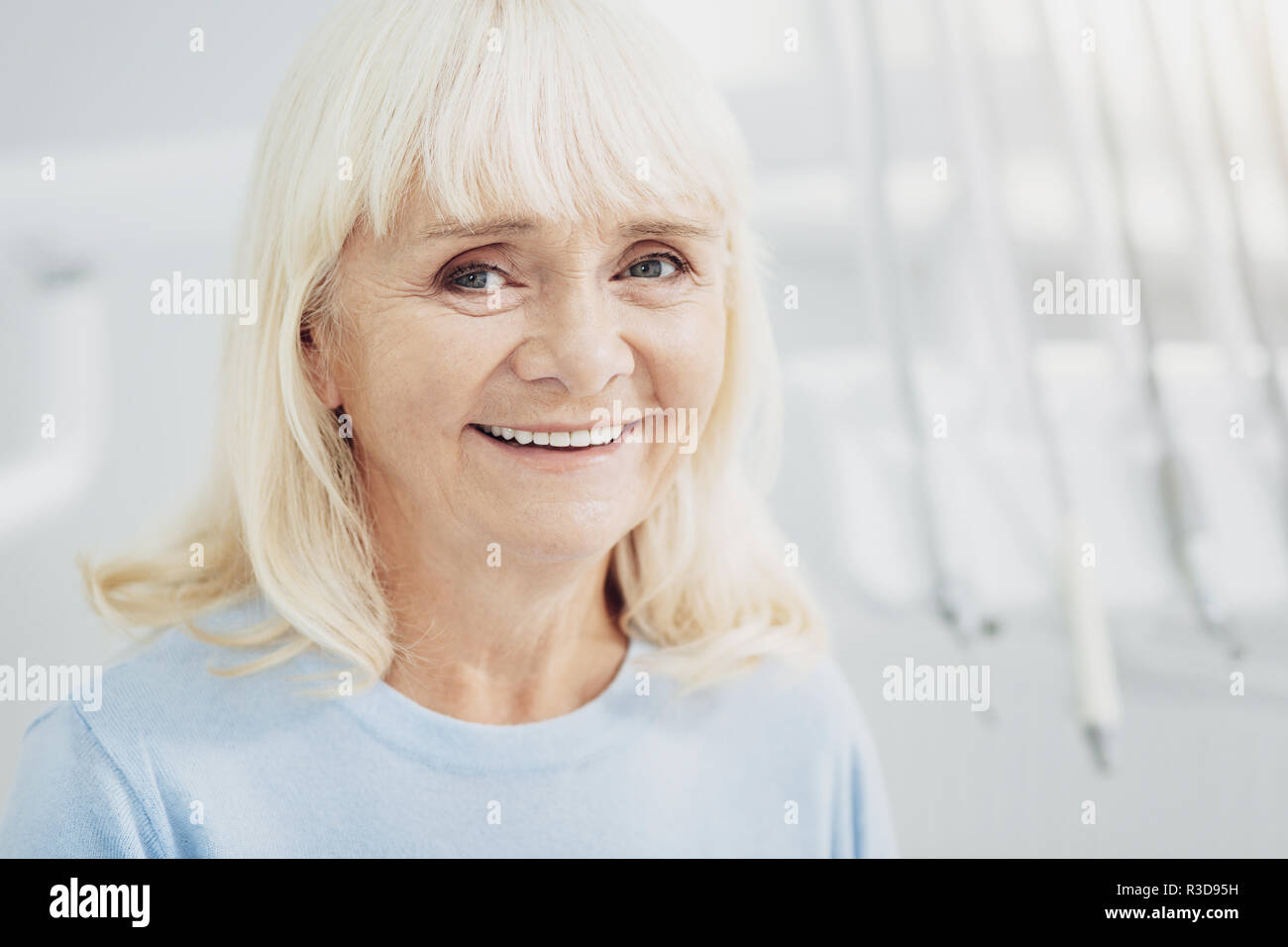 White smile. Cheerful senior woman grinning while staring at camera ...