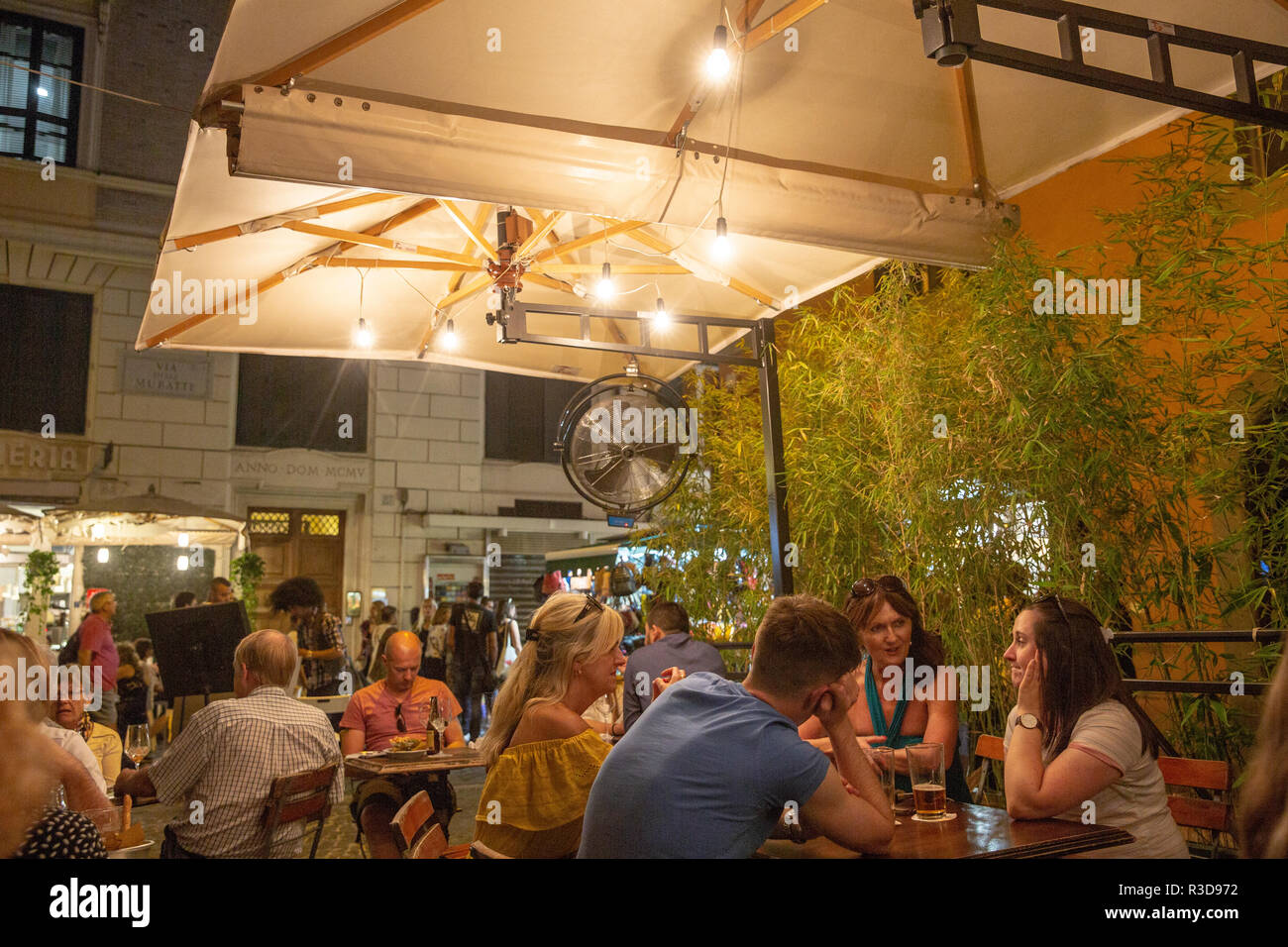 Rome Restaurant, Male and female friends socialising over evening ...