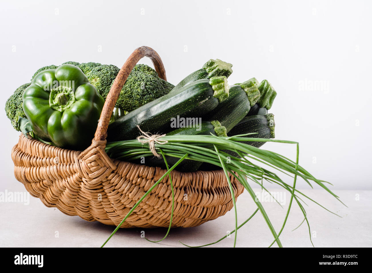 Green vegetables in the basket, local farmer market with assorted ...