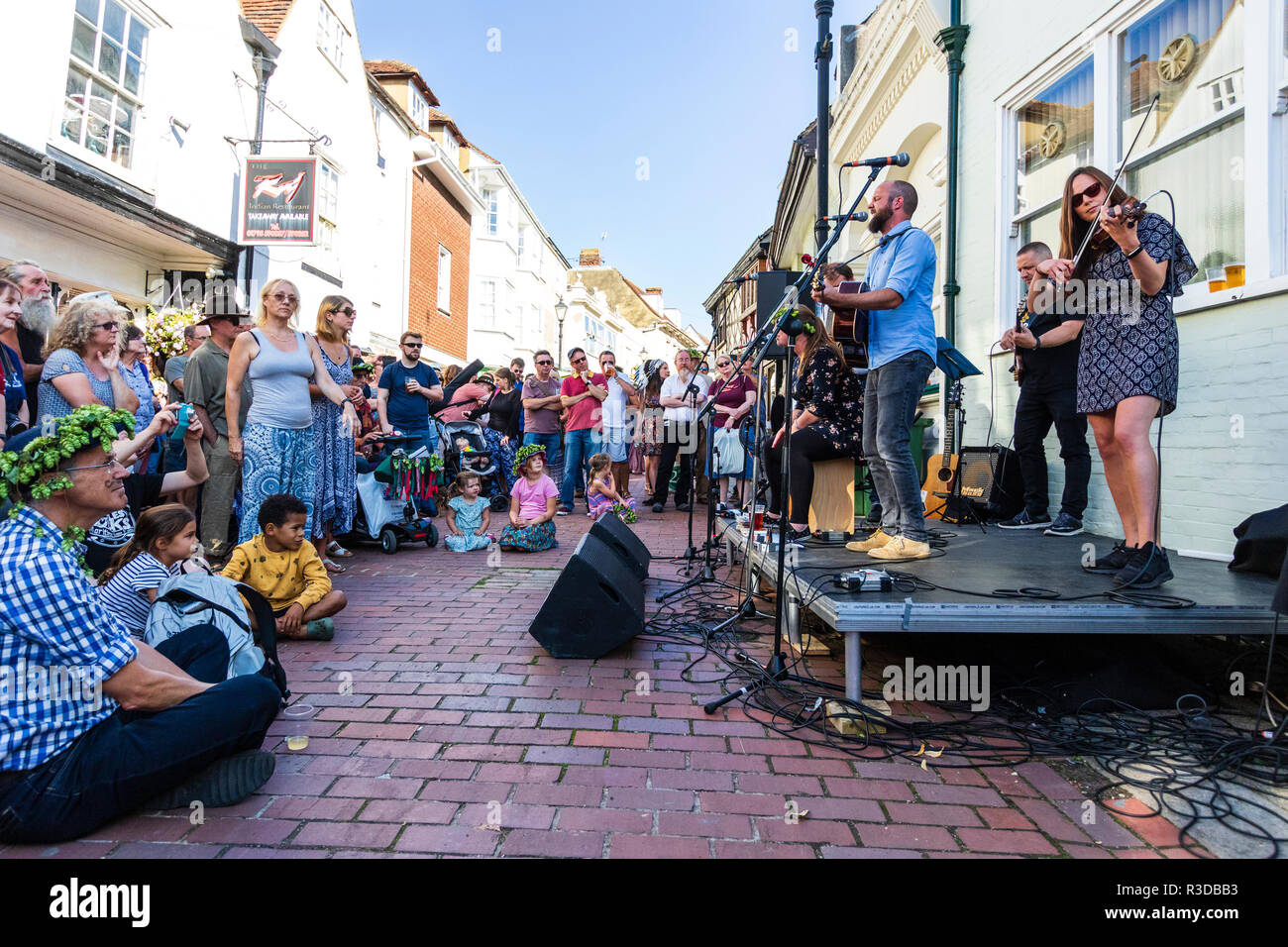 'Apples I'm home' pop folk band performing on small street stage at the ...