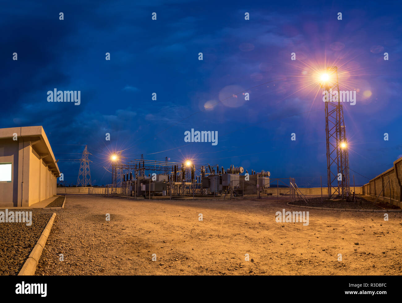 Electrical power substation illuminated by lights at night. Deliver ...