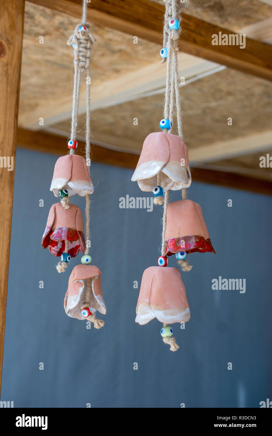 A bunch of colorful miniature bells hanging on display Stock Photo - Alamy