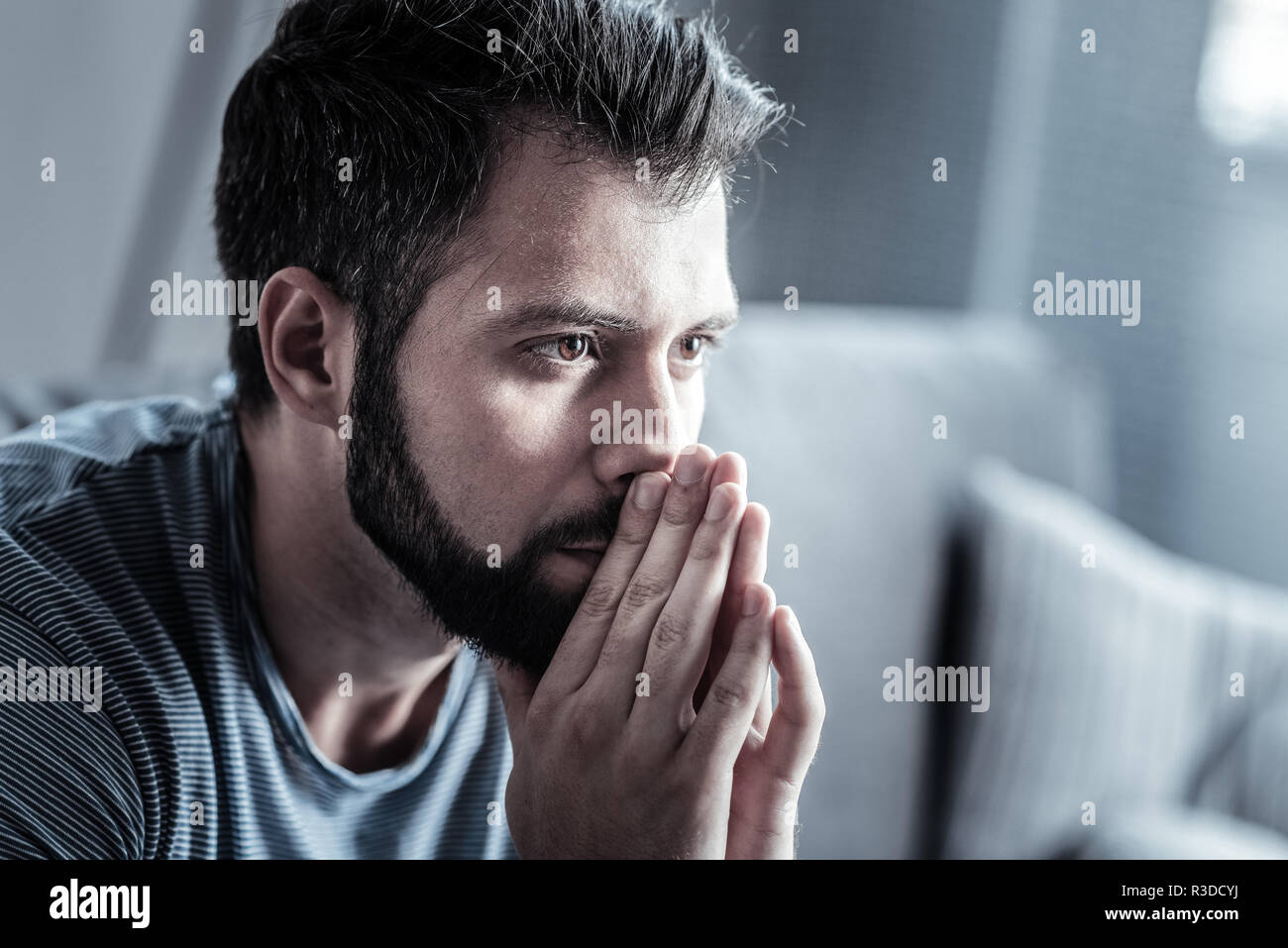 God help me. Handsome man thinking about future, looking forward and ...