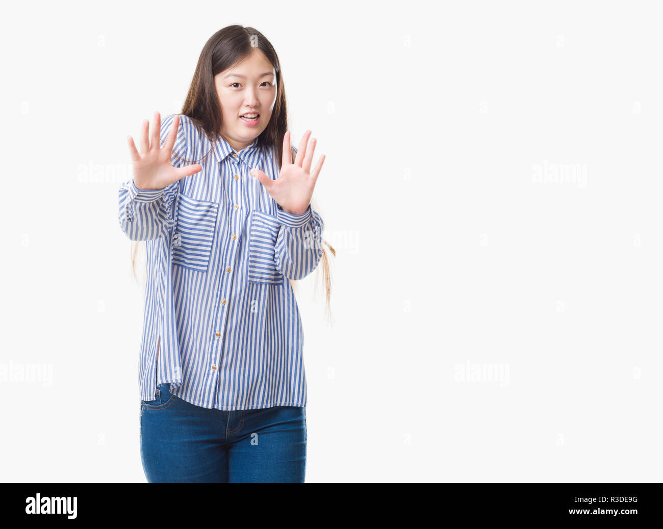 Young Chinese woman over isolated background afraid and terrified with ...