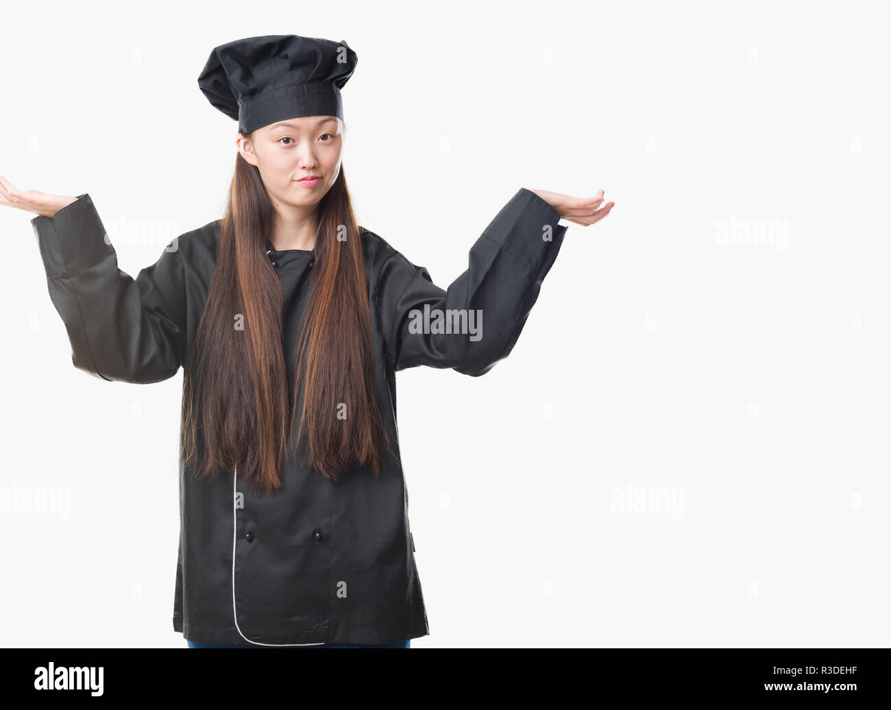 Young Chinese woman over isolated background wearing chef uniform ...
