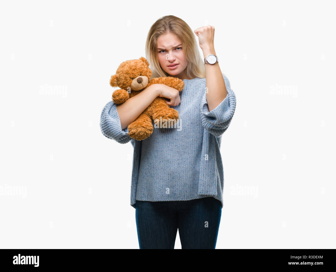 Young caucasian woman holding cute teddy bear over isolated background ...