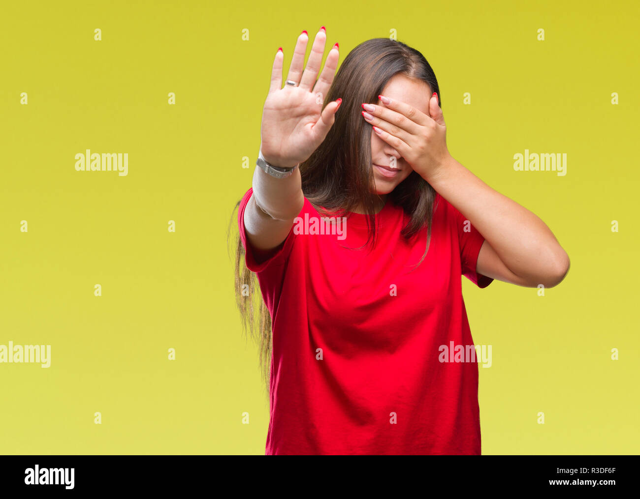 Young beautiful caucasian woman over isolated background covering eyes ...