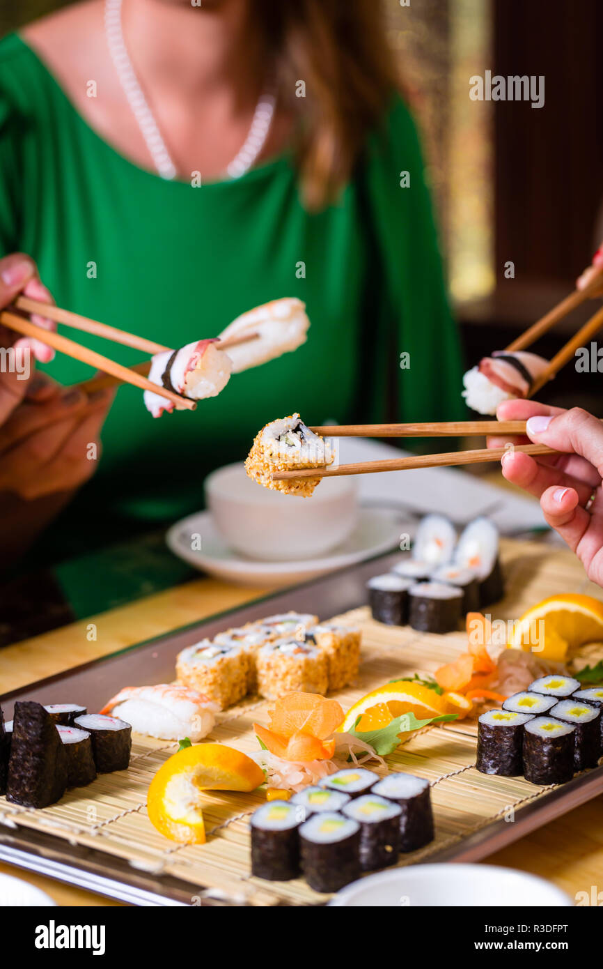 Nice woman eating sushi restaurant hi-res stock photography and images ...