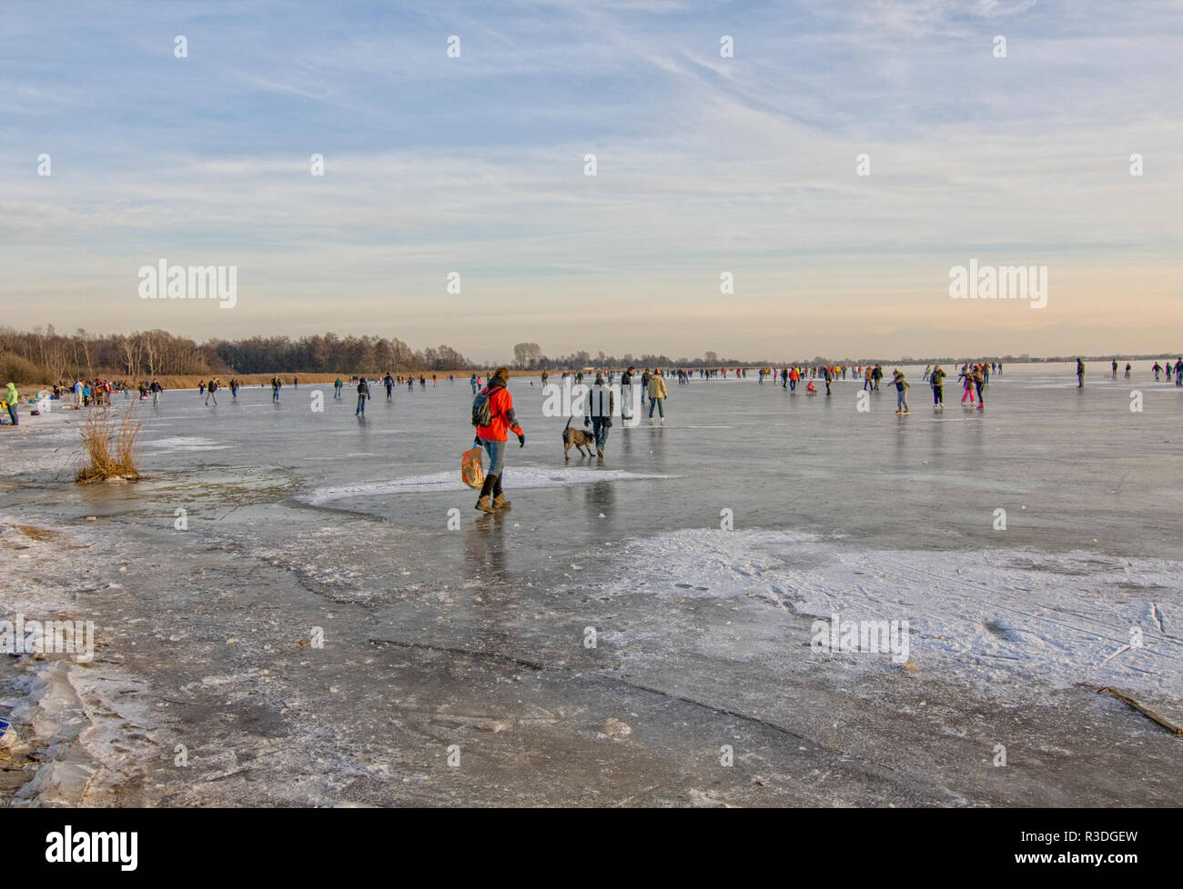 A typical icy sunday in the Netherlands. People walking, skating and ...