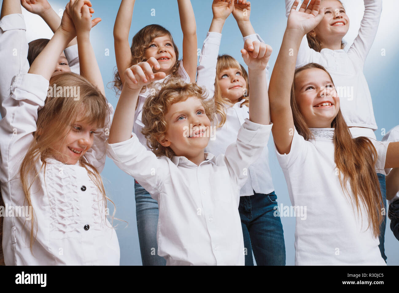 Adorable kids have fun together at birthday party. They playing ...