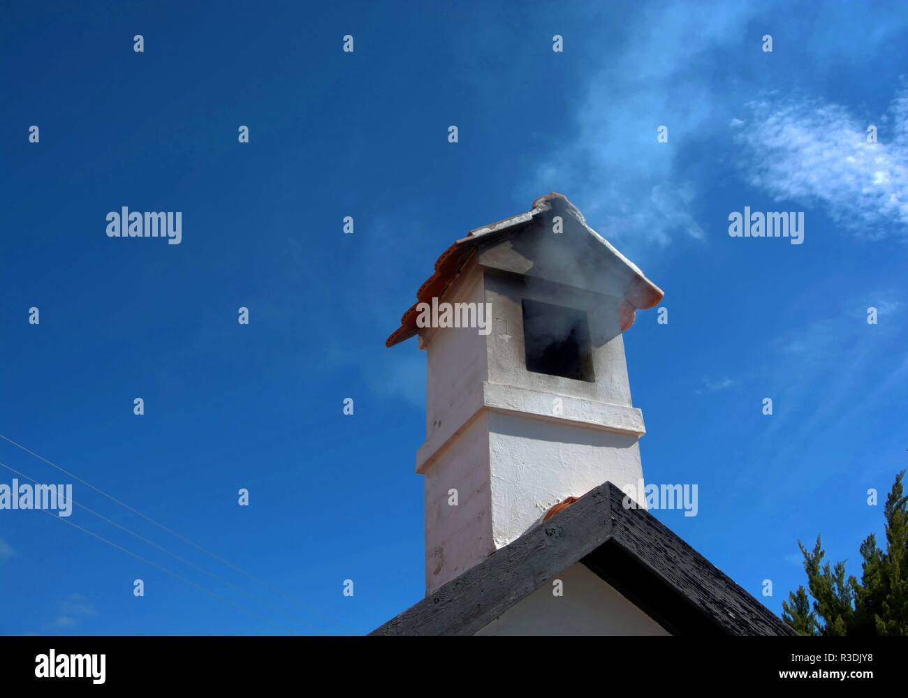 smoking stove of a stone oven under the blue sky Stock Photo - Alamy