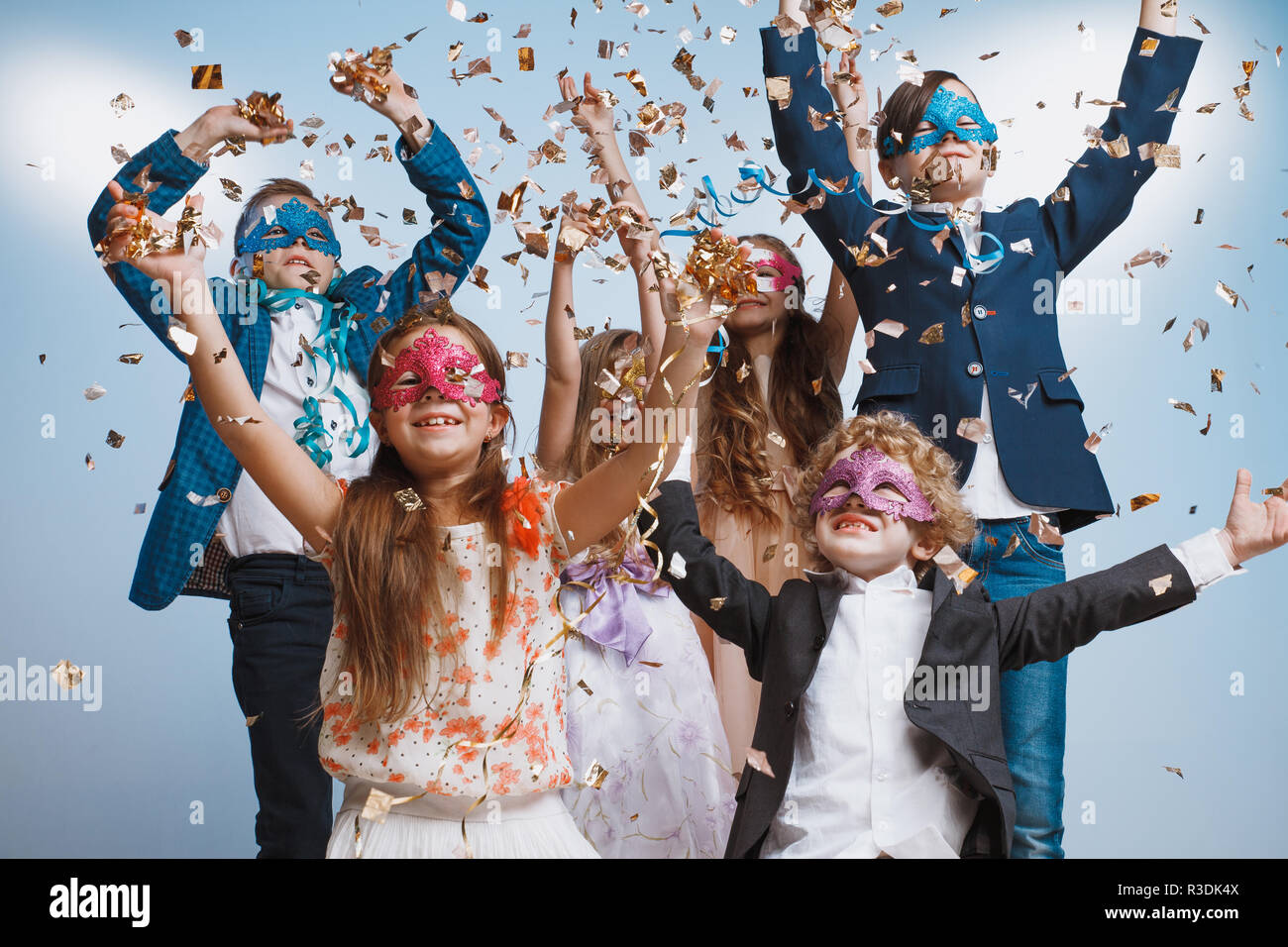 Adorable kids have fun together throw colourful confetti at birthday ...