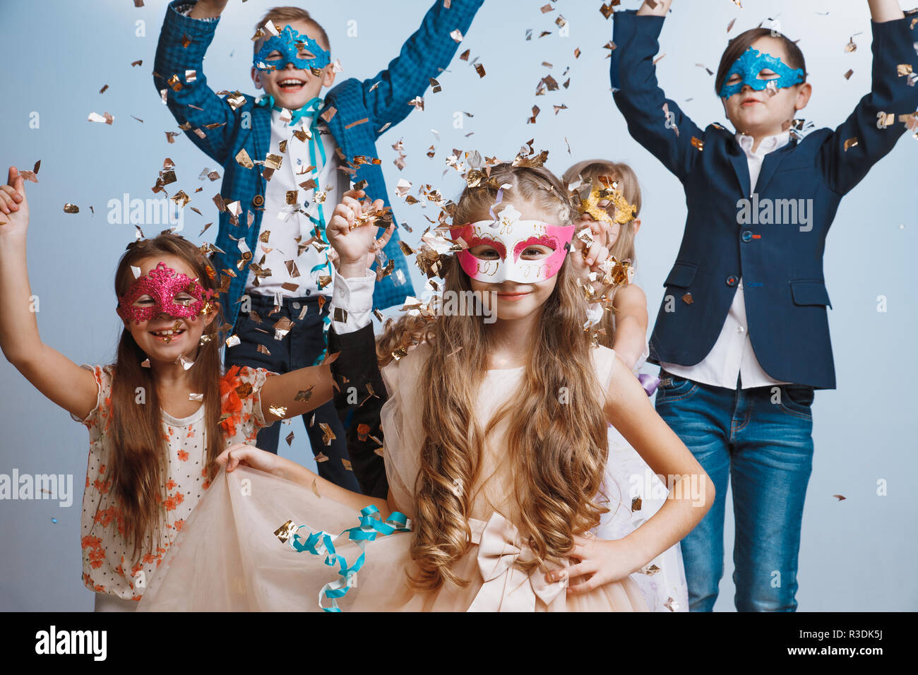 Adorable kids have fun together throw colourful confetti at birthday ...