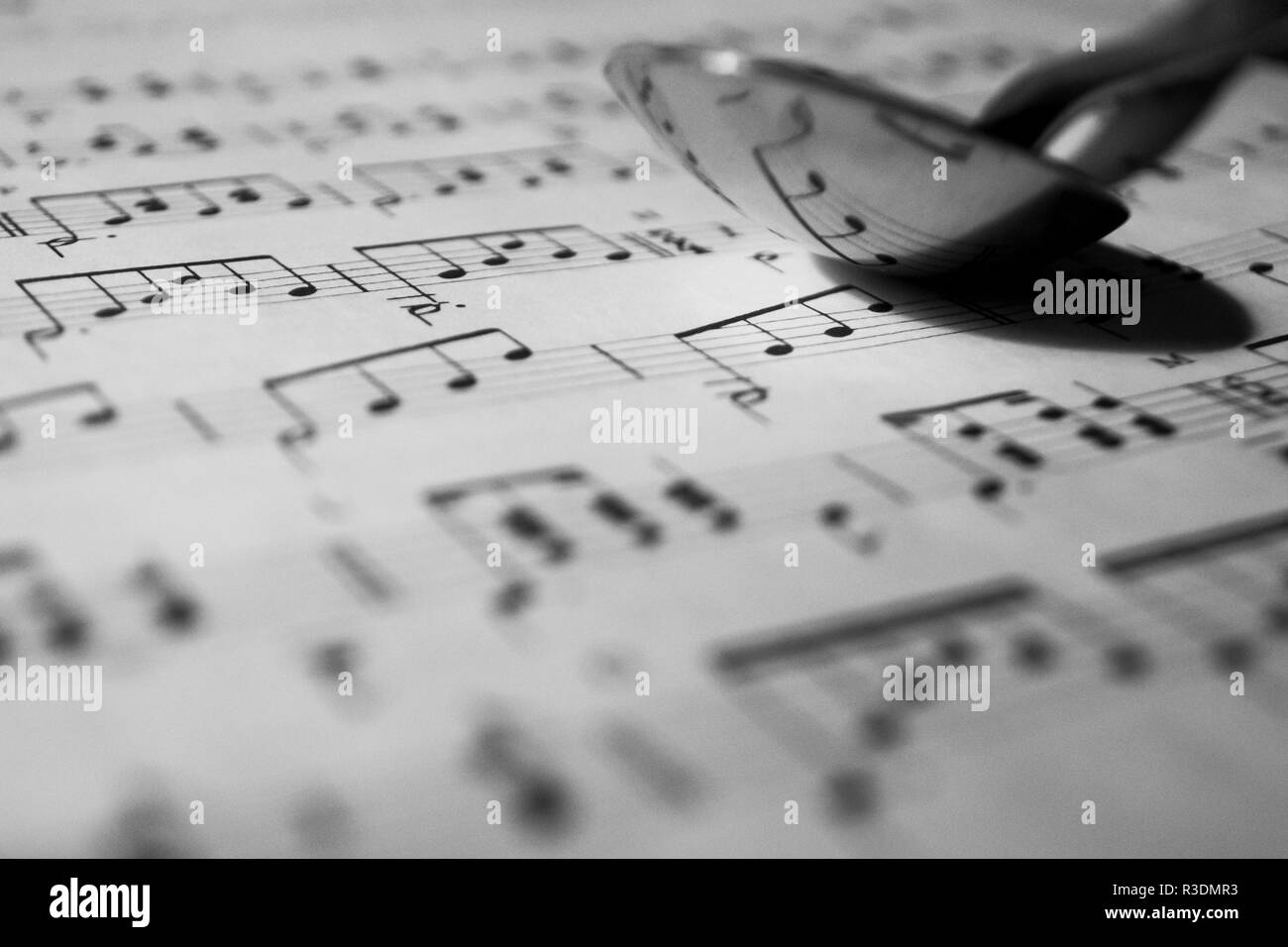The back of a spoon reflecting music notes Stock Photo - Alamy
