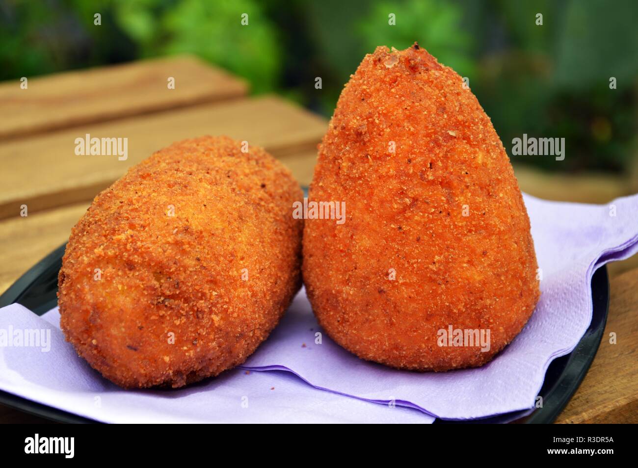 a couple of arancini, typical sicilian street food made with rice Stock ...