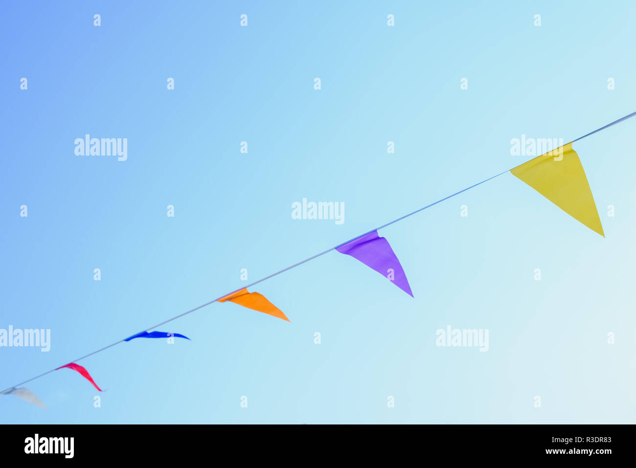 Colorful pennants with sky background to place text Stock Photo - Alamy