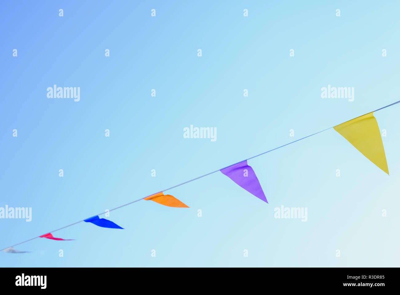 Colorful pennants with sky background to place text Stock Photo - Alamy