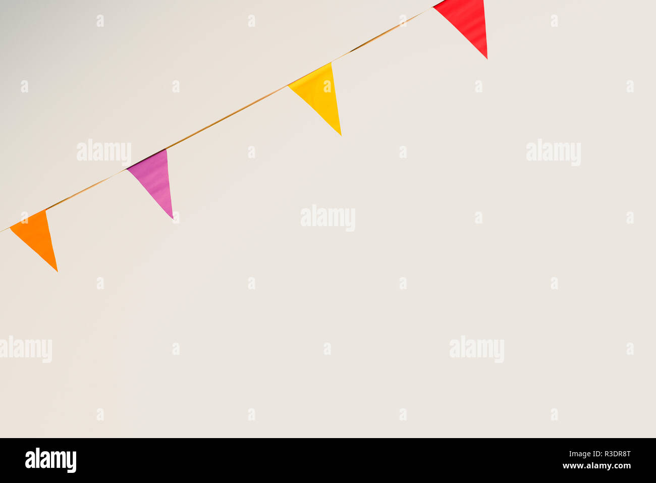 Colorful pennants with sky background to place text Stock Photo - Alamy