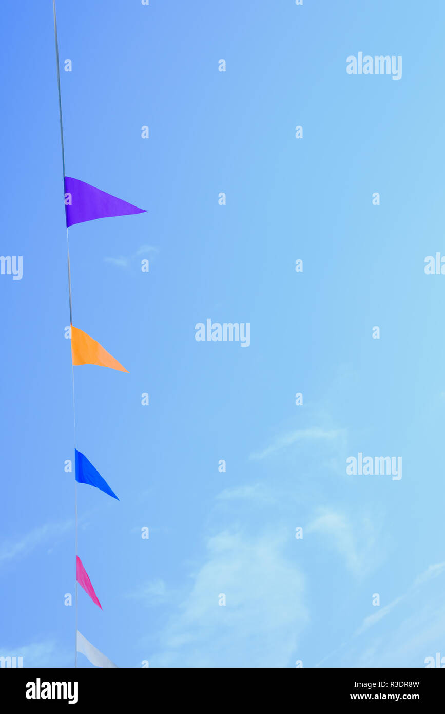 Colorful pennants with sky background to place text Stock Photo - Alamy
