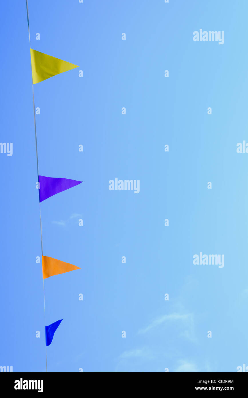 Colorful pennants with sky background to place text Stock Photo - Alamy