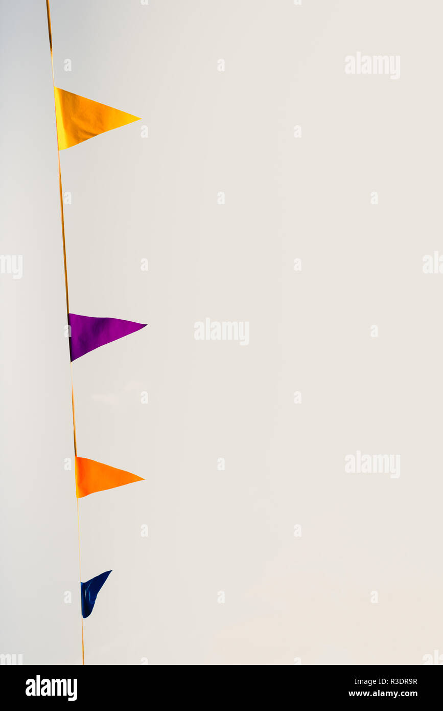 Colorful pennants with sky background to place text Stock Photo - Alamy