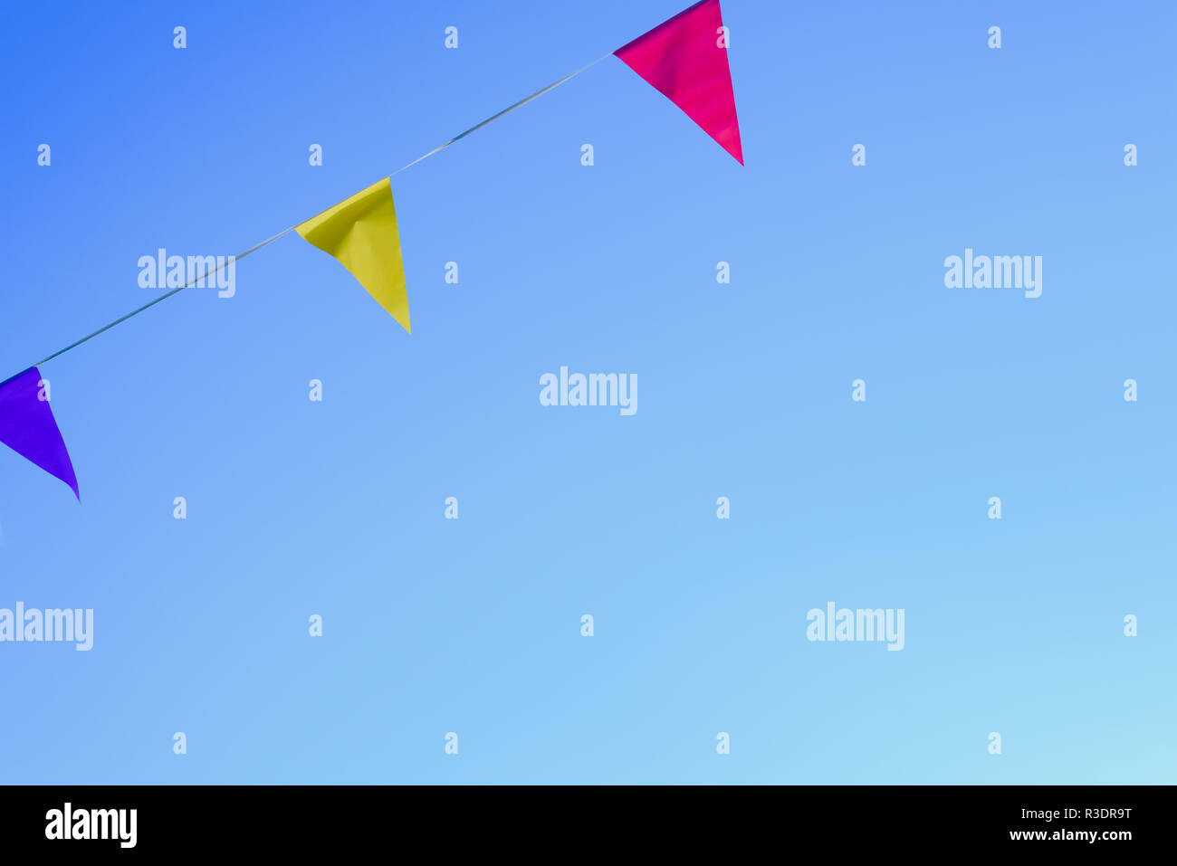 Colorful pennants with sky background to place text Stock Photo - Alamy