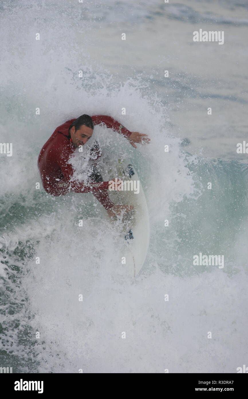 Experienced white male wetsuit surfer Stock Photo - Alamy
