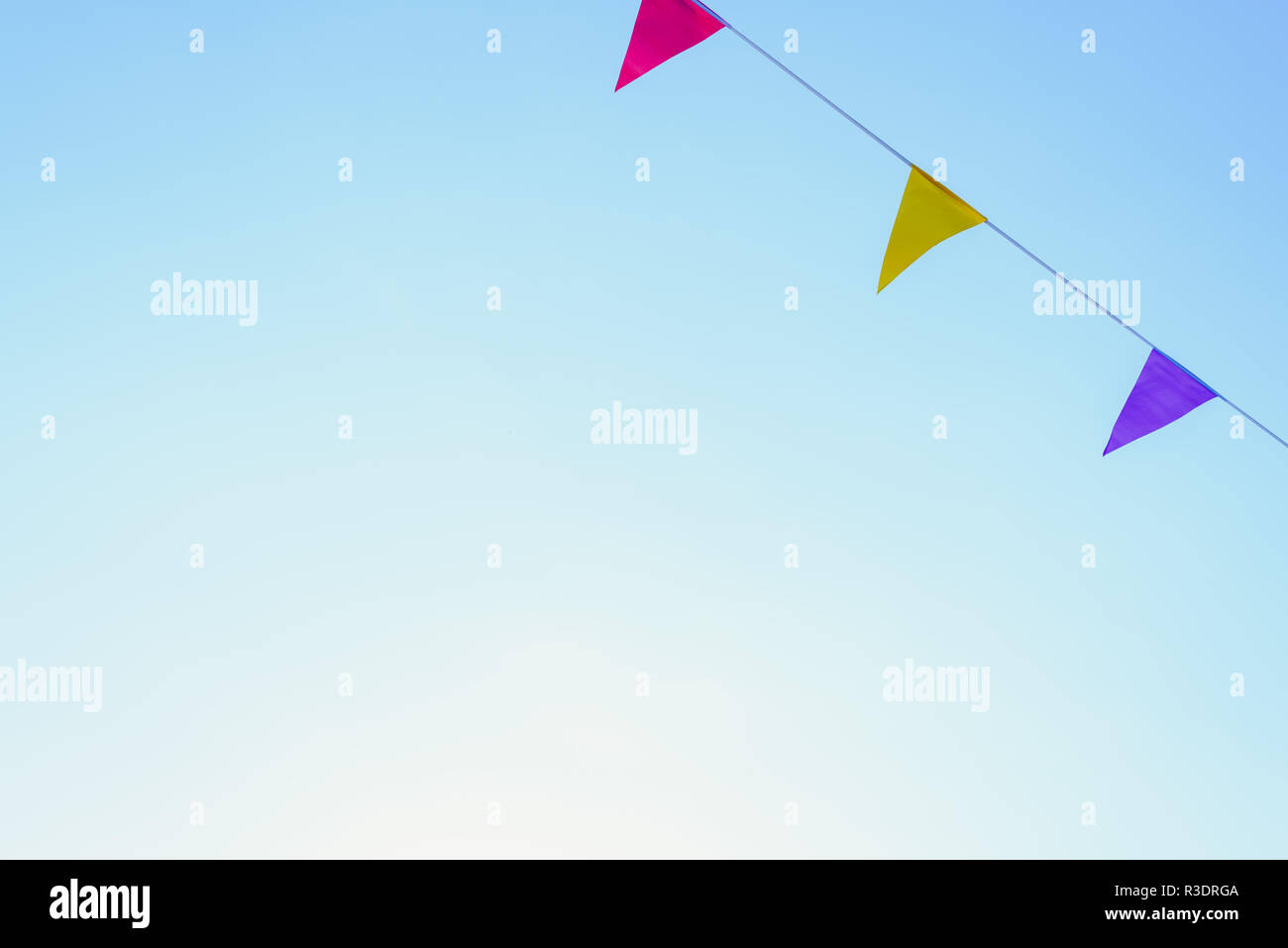 Colorful pennants with sky background to place text Stock Photo - Alamy