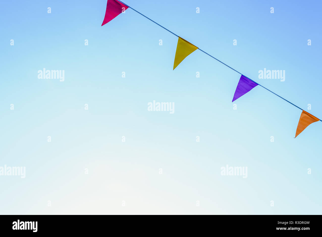 Colorful pennants with sky background to place text Stock Photo - Alamy