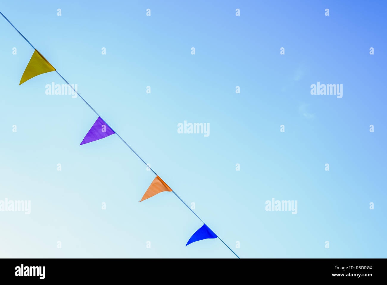 Colorful pennants with sky background to place text Stock Photo - Alamy