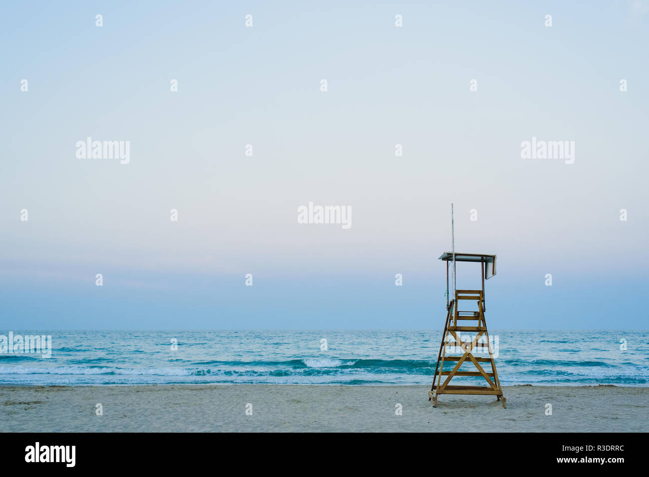 Lifeguard watchtower on the beach at sunset Stock Photo - Alamy