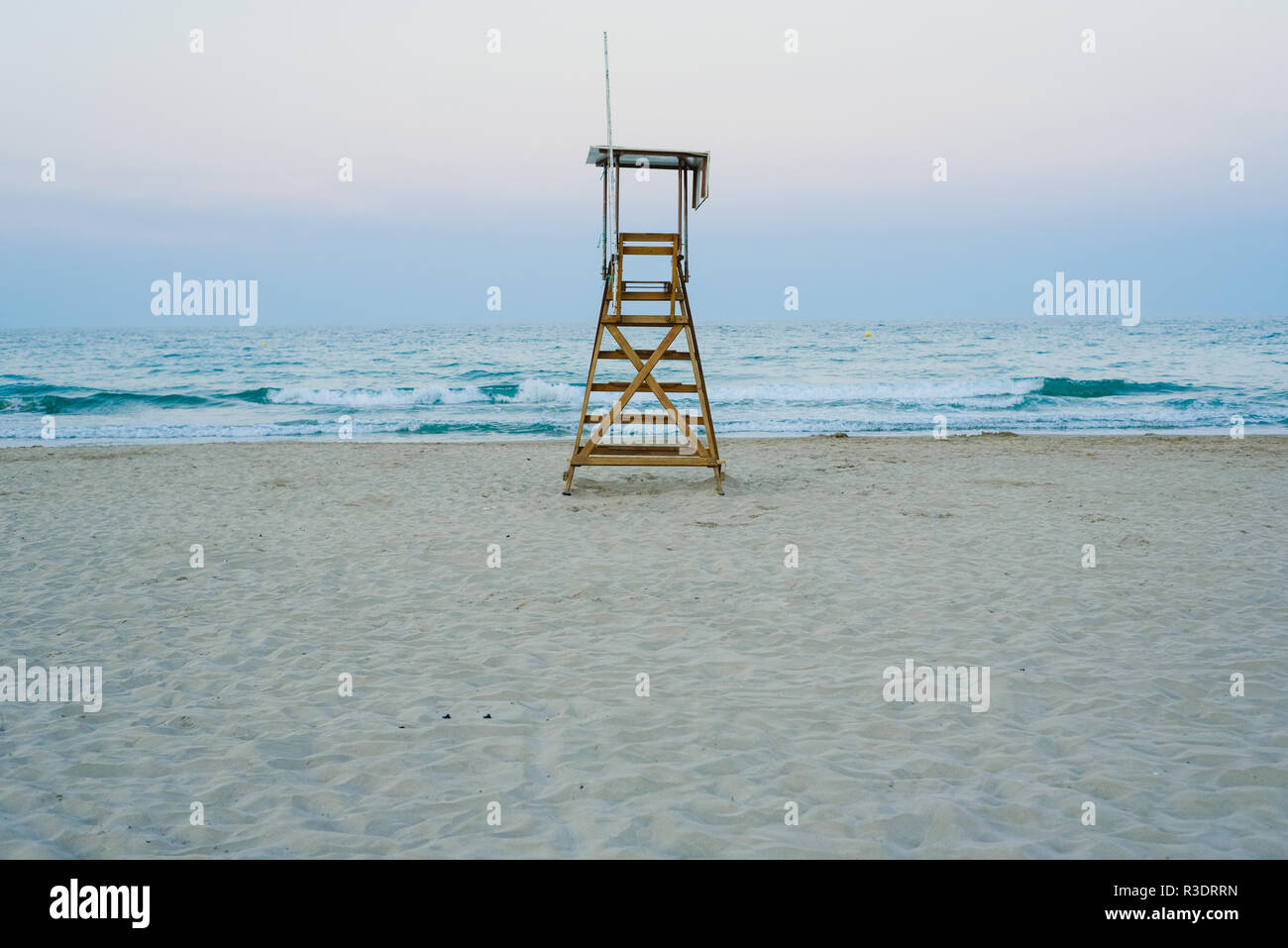 Lifeguard watchtower on the beach at sunset Stock Photo - Alamy